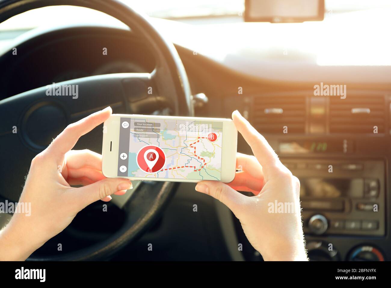 Woman using smartphone in car. Map application concept Stock Photo - Alamy