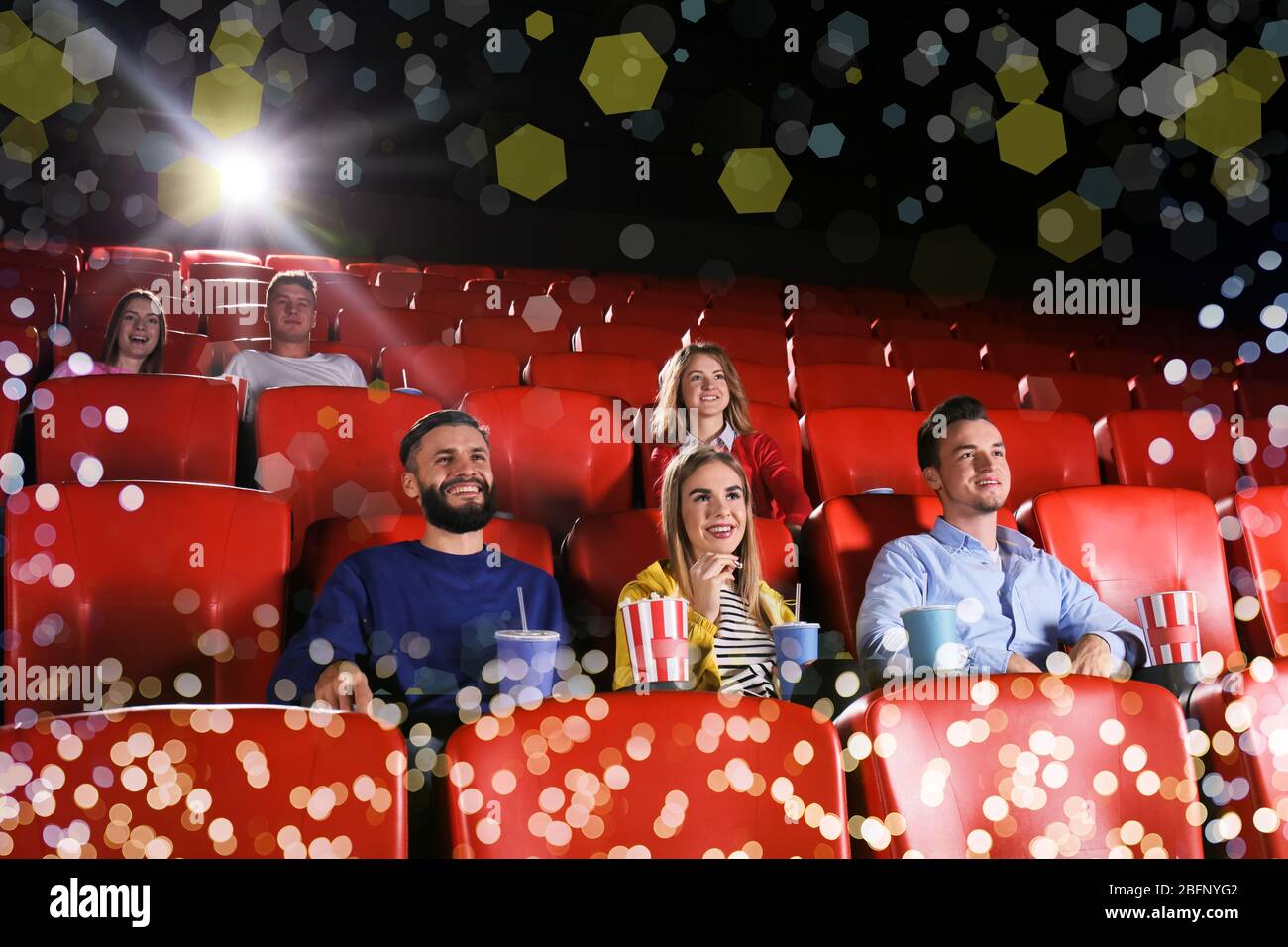 Young people watching movie in cinema. Frame of blurred lights Stock ...