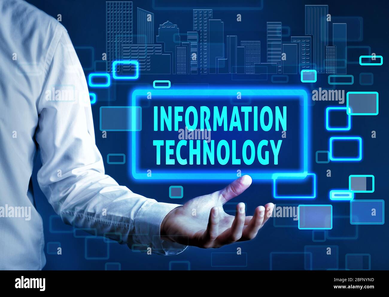 Businessman holding virtual icon with text INFORMATION TECHNOLOGY ...