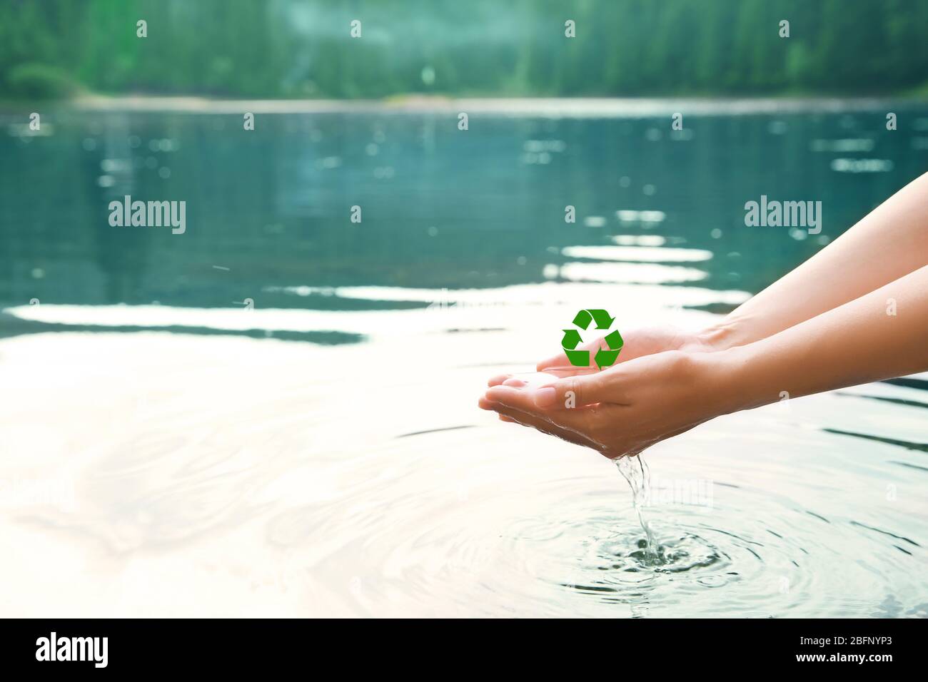 Woman holding water in hands over lake. Recycling concept. Save nature ...
