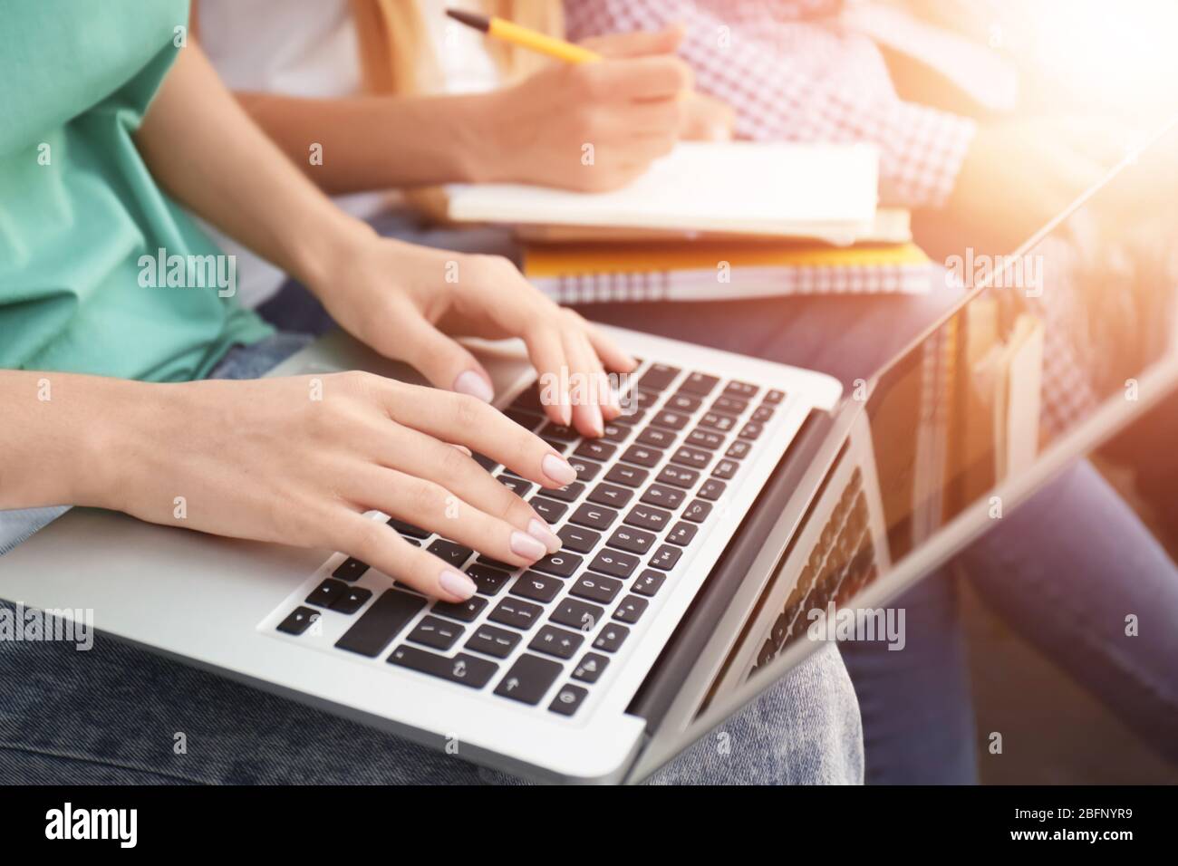 Student with laptop doing homework assignment, closeup Stock Photo - Alamy