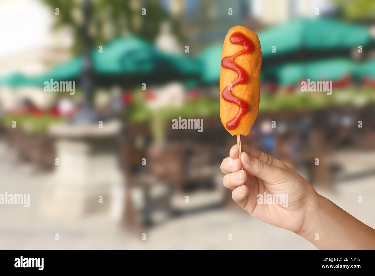 Woman eating corn dog hi-res stock photography and images - Alamy