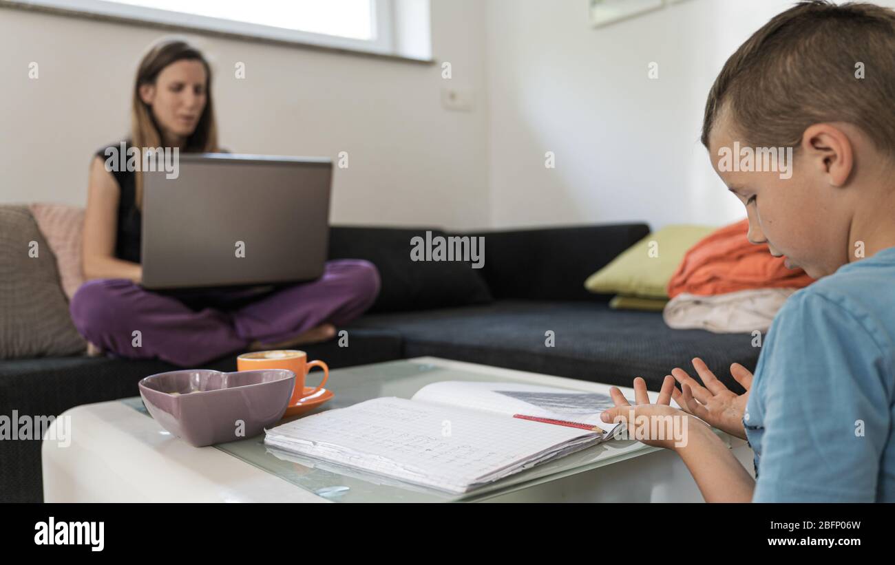 Home schooling conceptual image - young mother working on laptop ...
