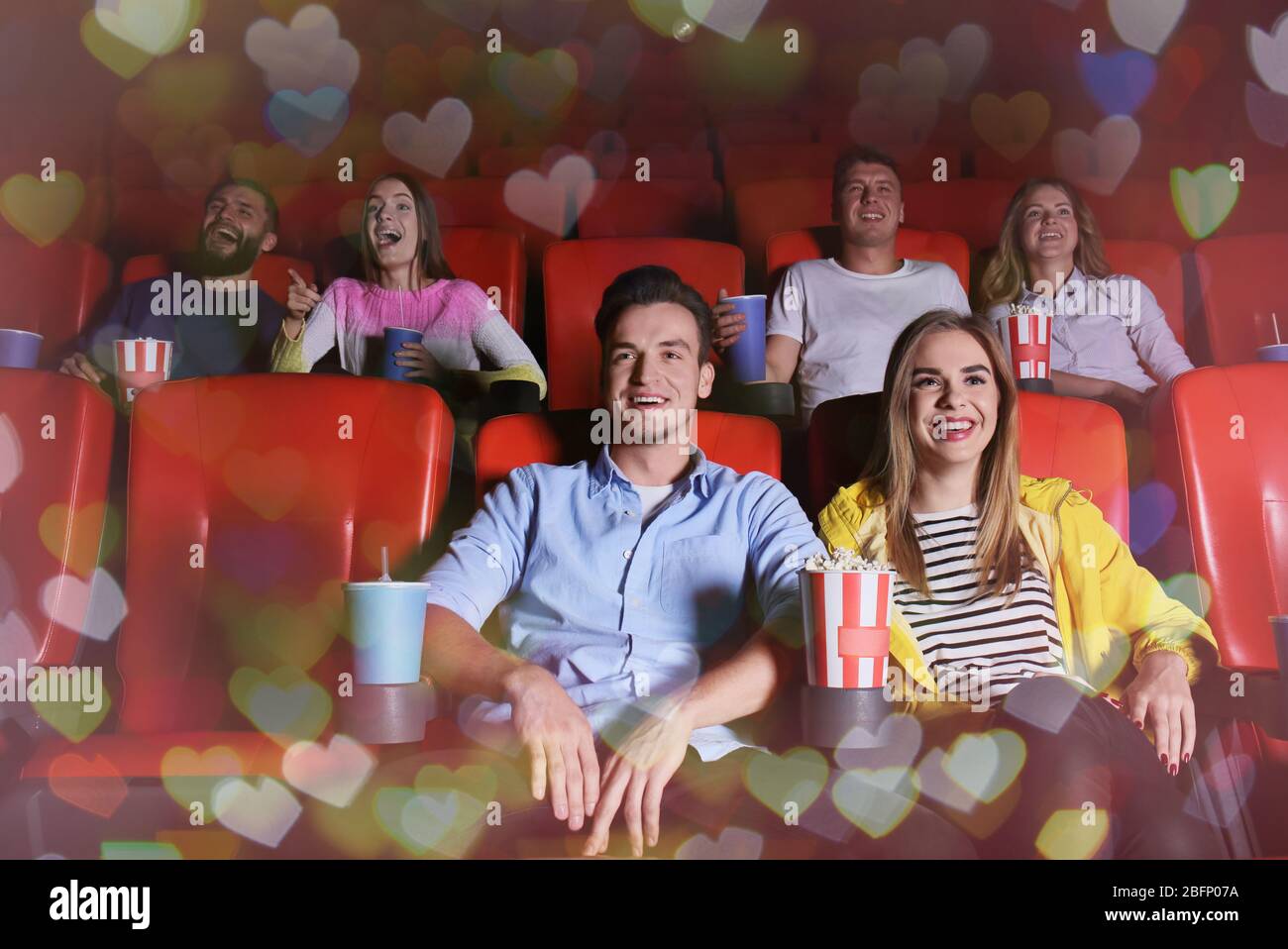 Young people watching movie in cinema. Frame of blurred lights Stock ...