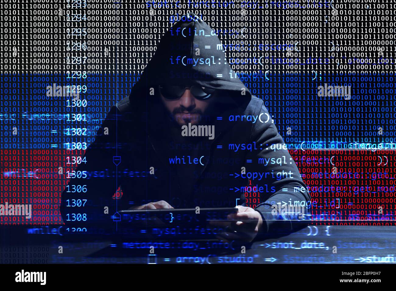 Hacker working with tablet at table and flag of Russia on background ...