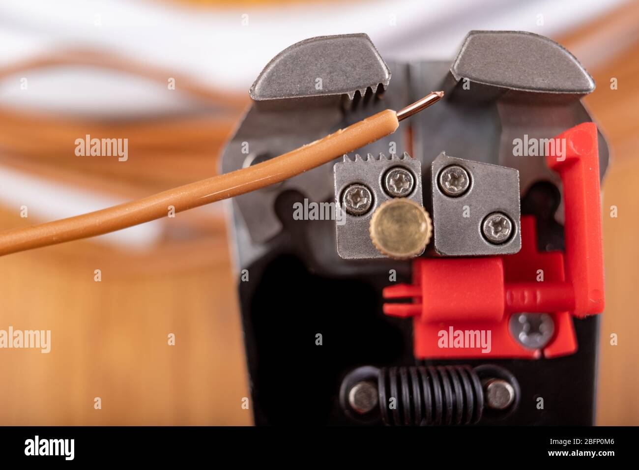 Removing protective insulation from electrical wires. Small work in the ...