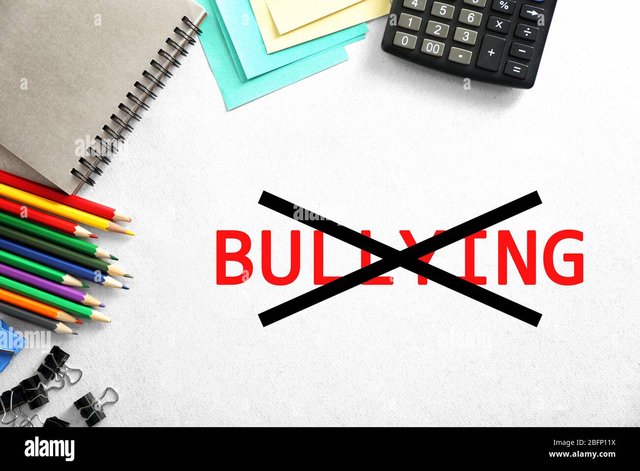 Office stationery and crossed out word BULLYING on light background ...