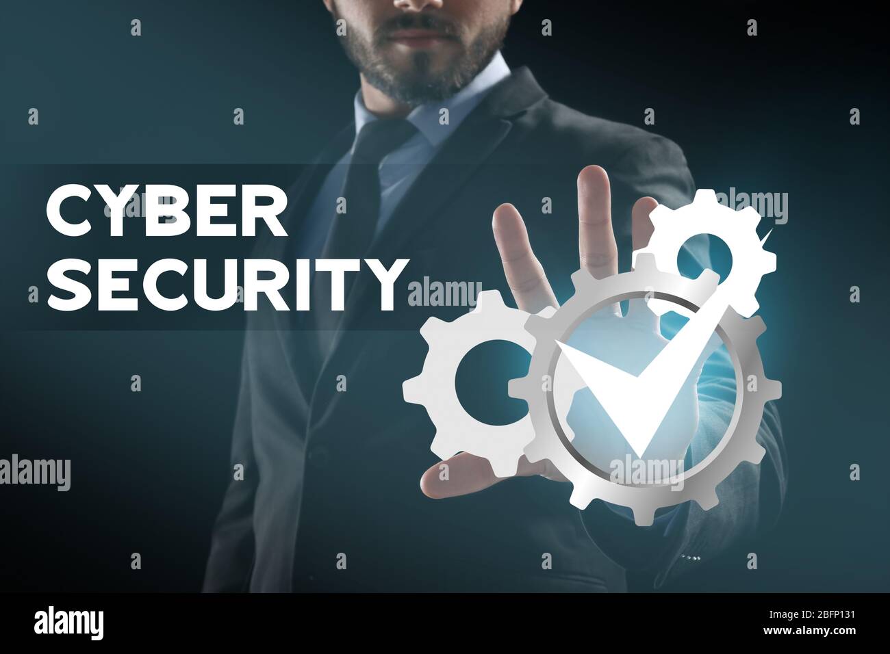 Businessman with virtual gears and check mark against dark background ...
