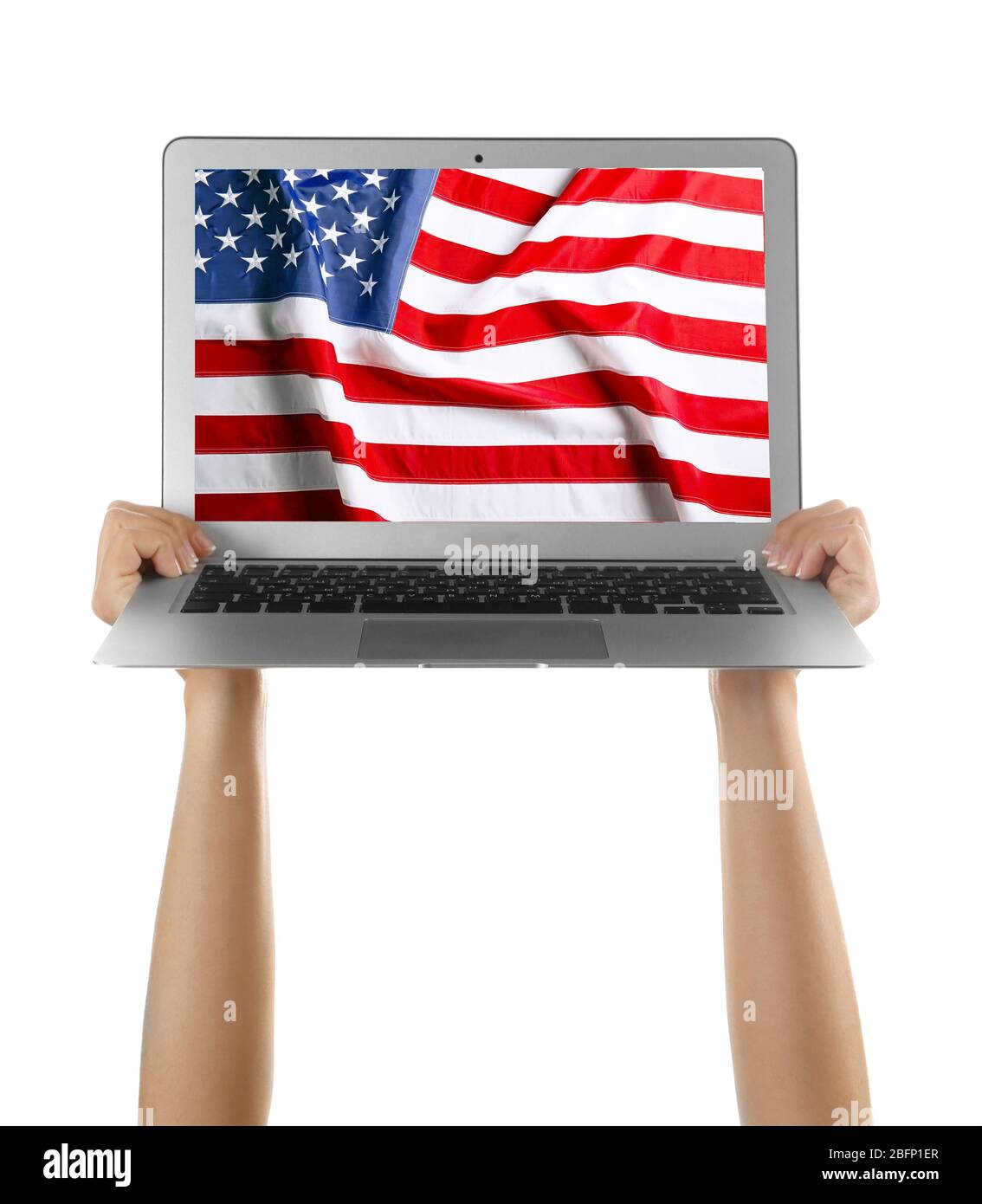 Young woman holding laptop with American flag on screen against white ...