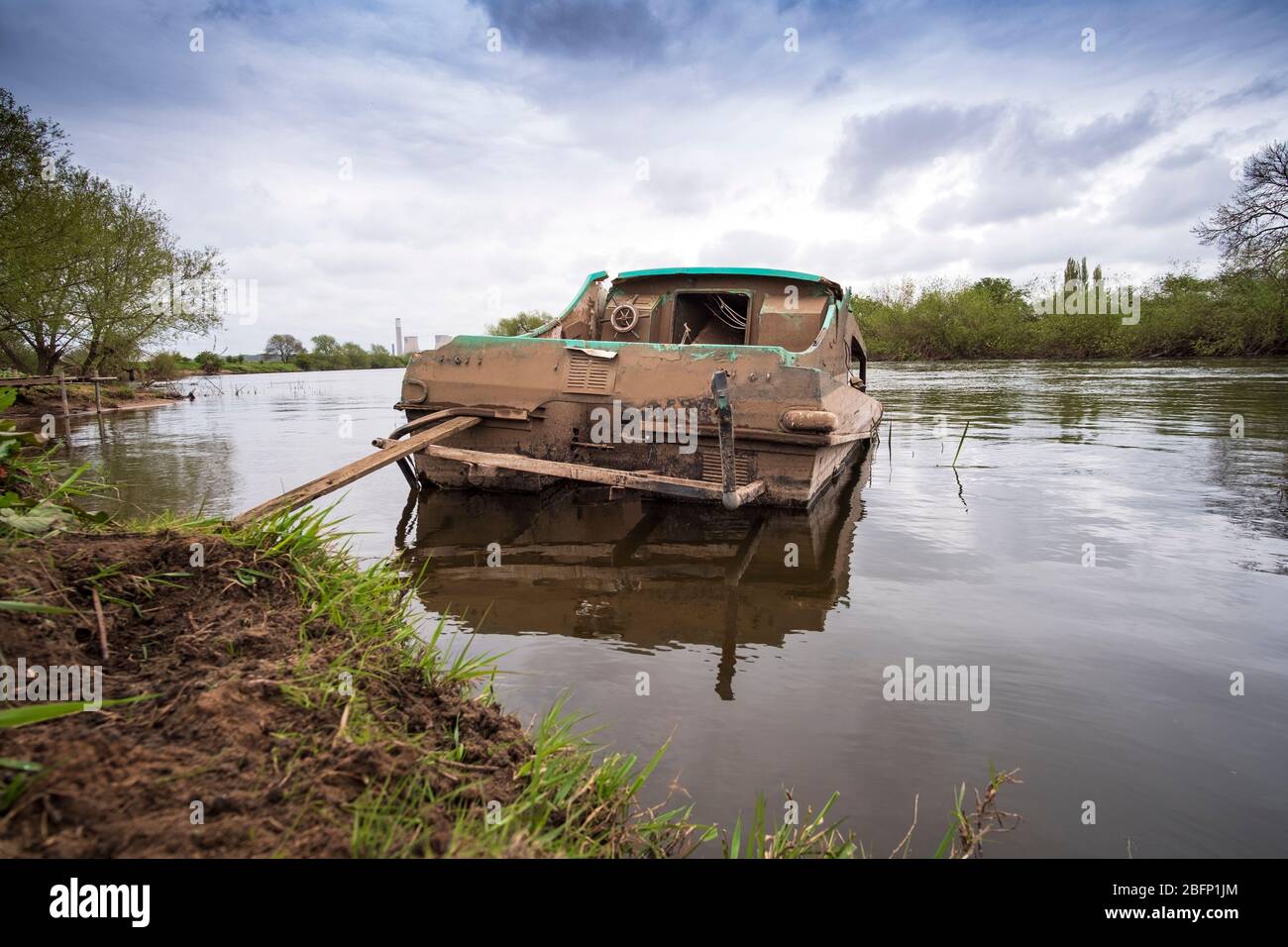 Small river boat sunk during floods Stock Photo - Alamy