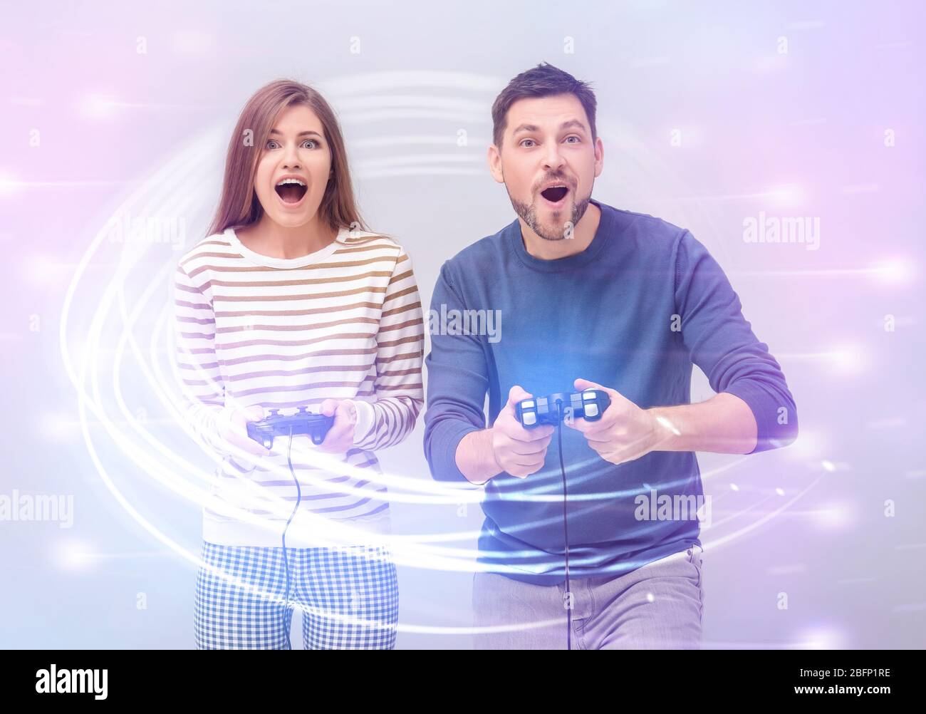 People with controllers playing video game on light background ...