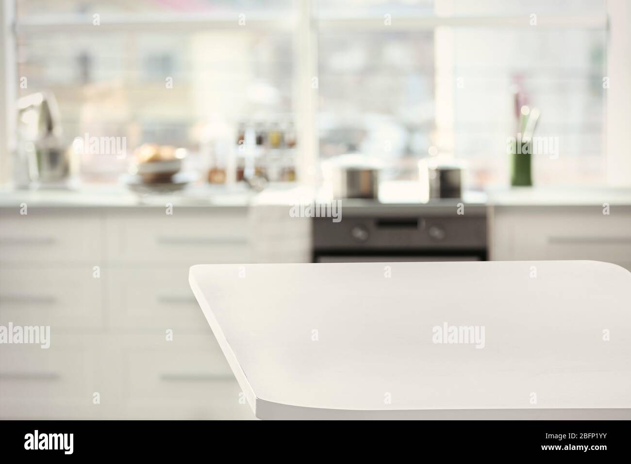 Empty wooden table and blurred kitchen background Stock Photo - Alamy