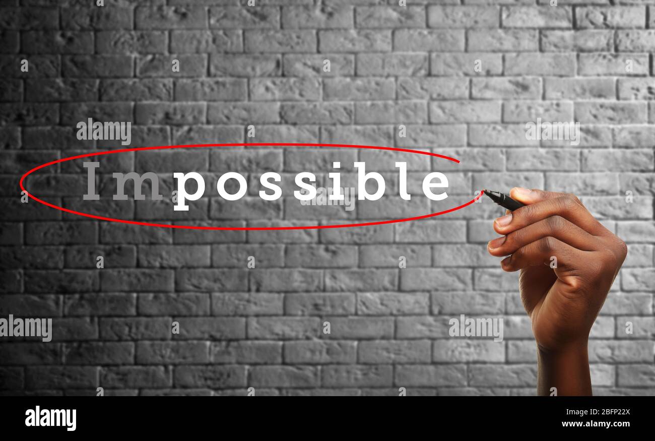 Human hand turning word impossible into possible Stock Photo - Alamy