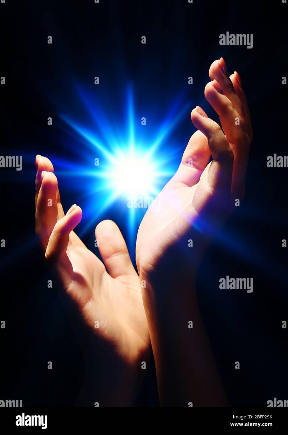 Light in hands. Concept of taking, care, protection Stock Photo - Alamy