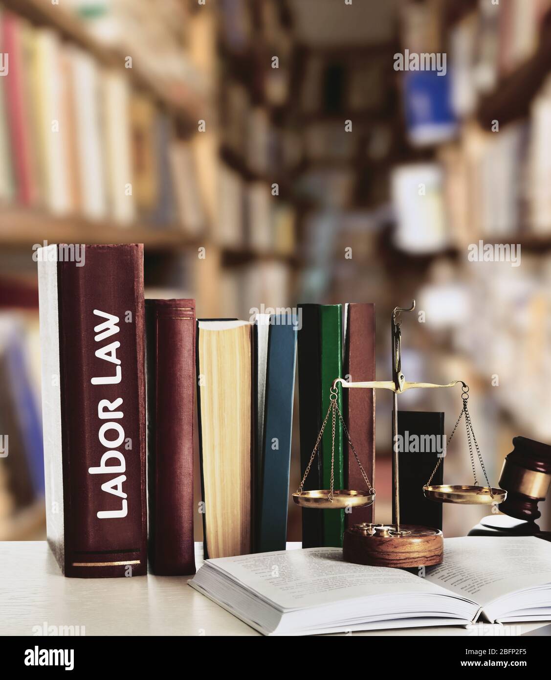 Wooden gavel with justice scales on table in library Stock Photo - Alamy