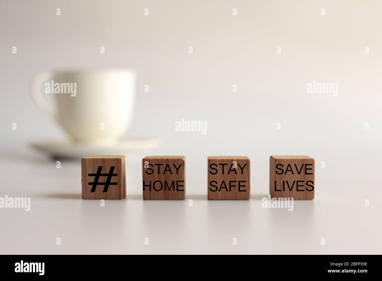 Concept image a wooden block and words STAY HOME, STAY SAFE, SAVE LIVES ...