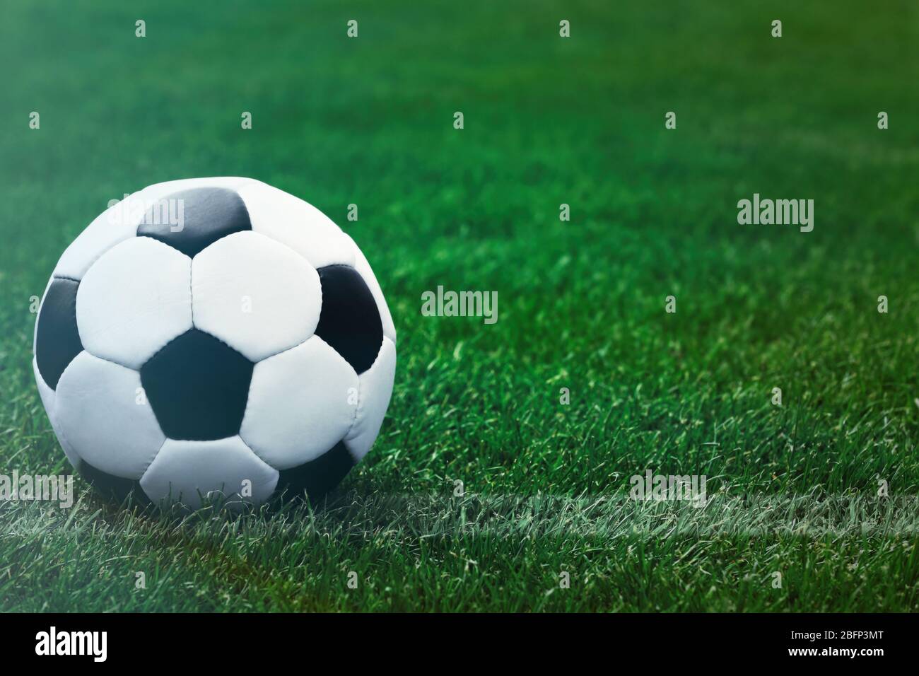 Soccer football field stadium and ball on green grass Stock Photo - Alamy