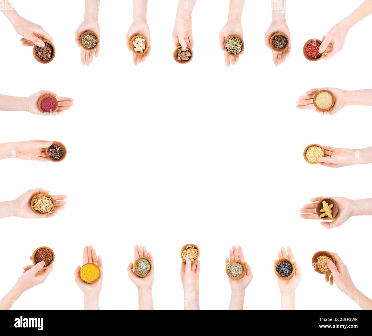 Hands holding collection of different spices in wooden bowls, isolated ...