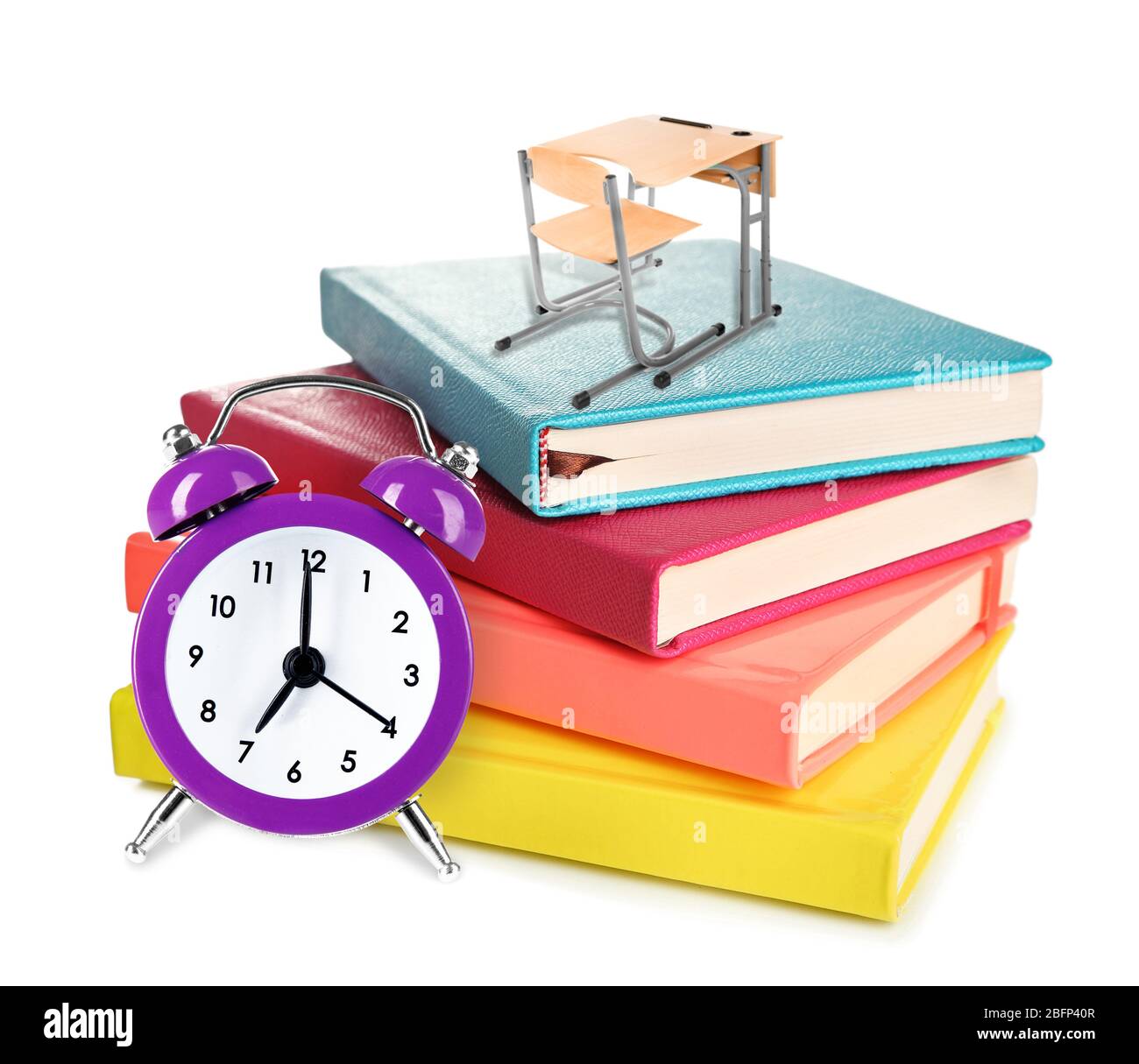 Little wooden desk and chair on colorful notebooks with alarm clock ...