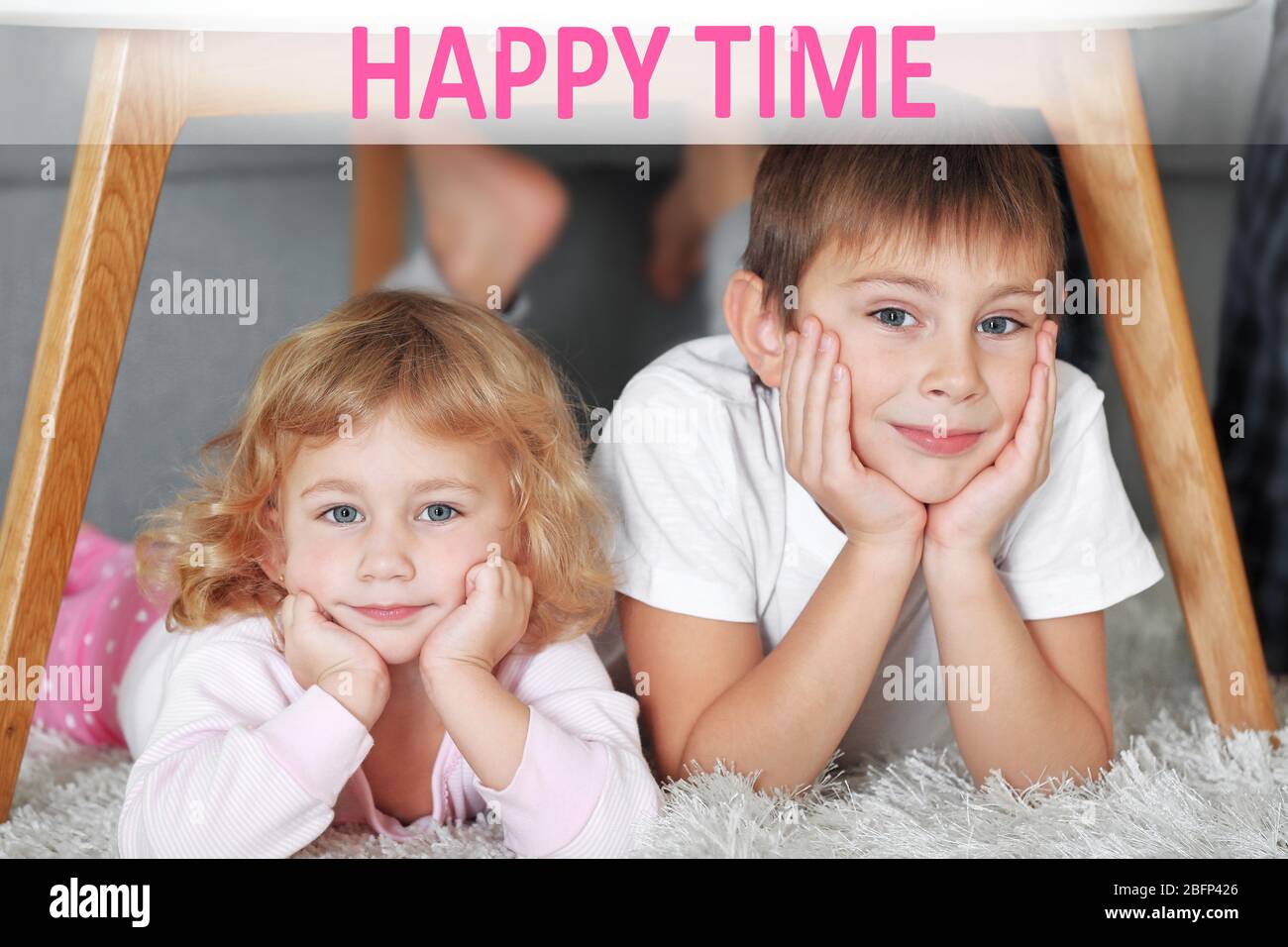 Text Happy Time and cute little children playing under table Stock ...