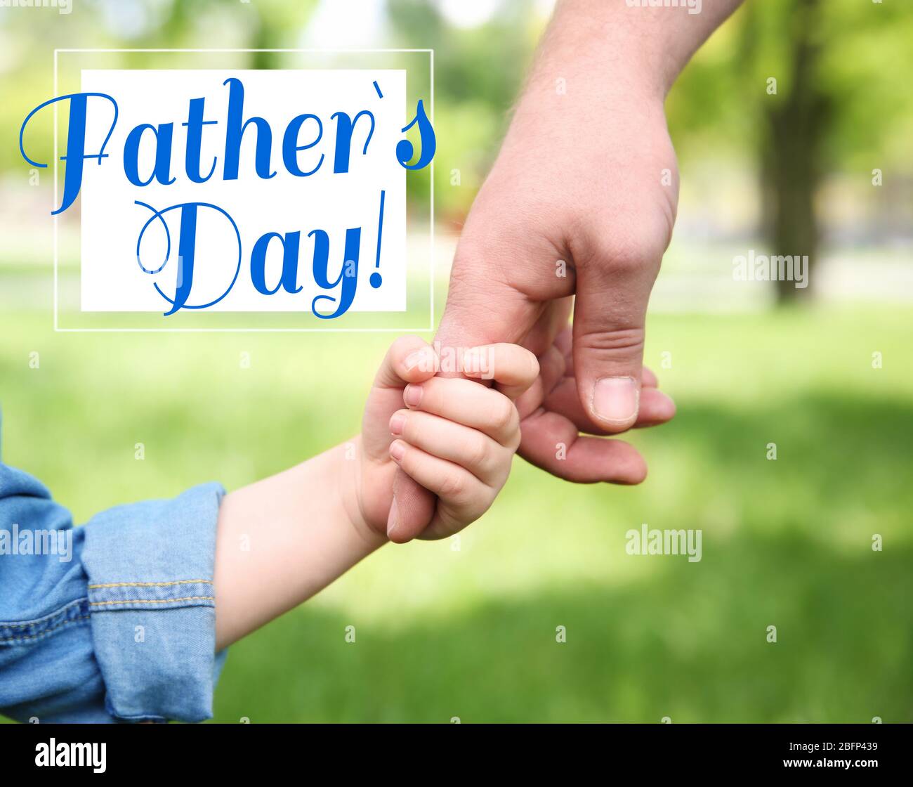 Happy father's day concept. Adult and child hands on natural background ...