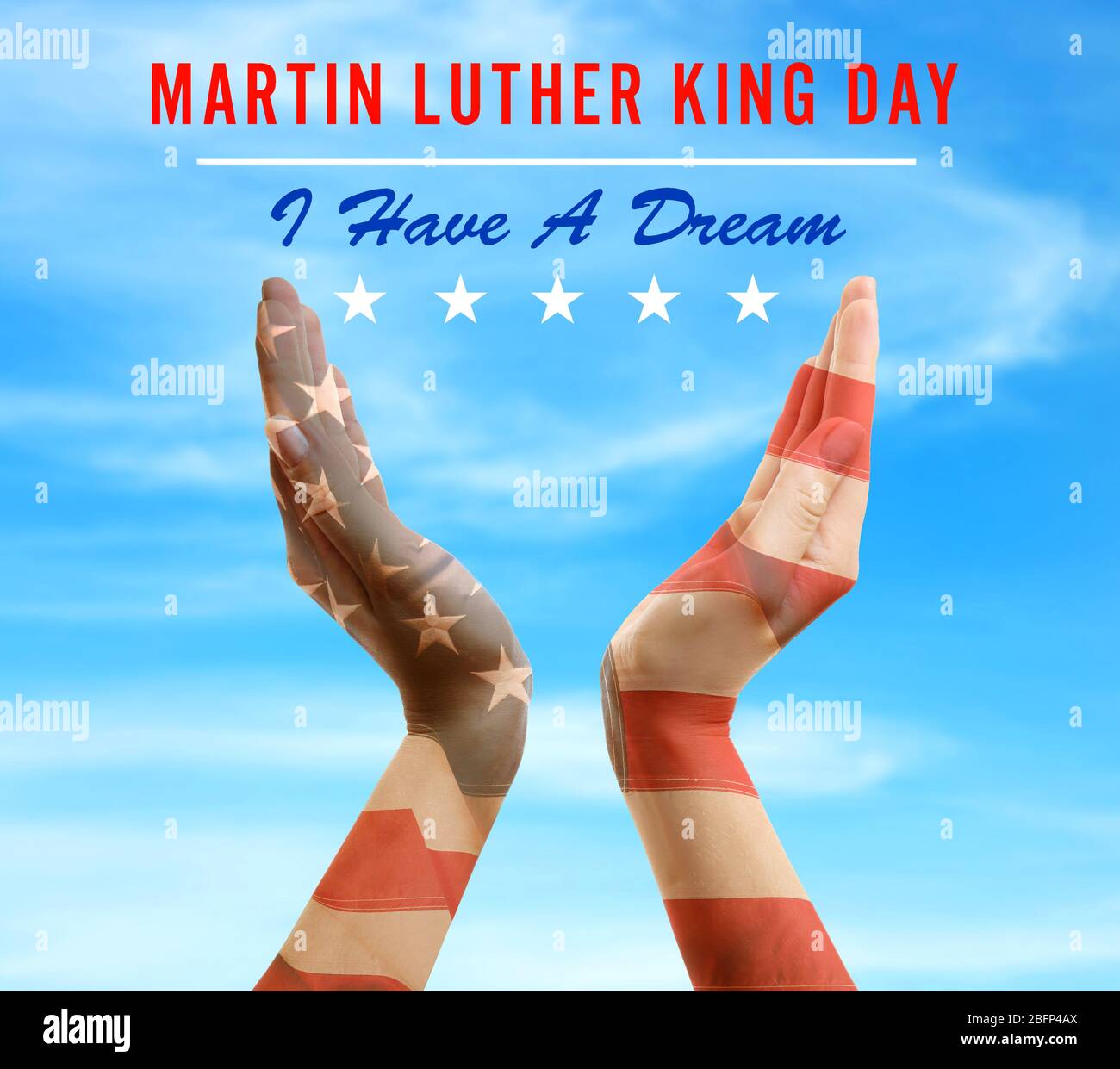 Martin Luther King Day. Text I Have a Dream in hands,on blue sky ...