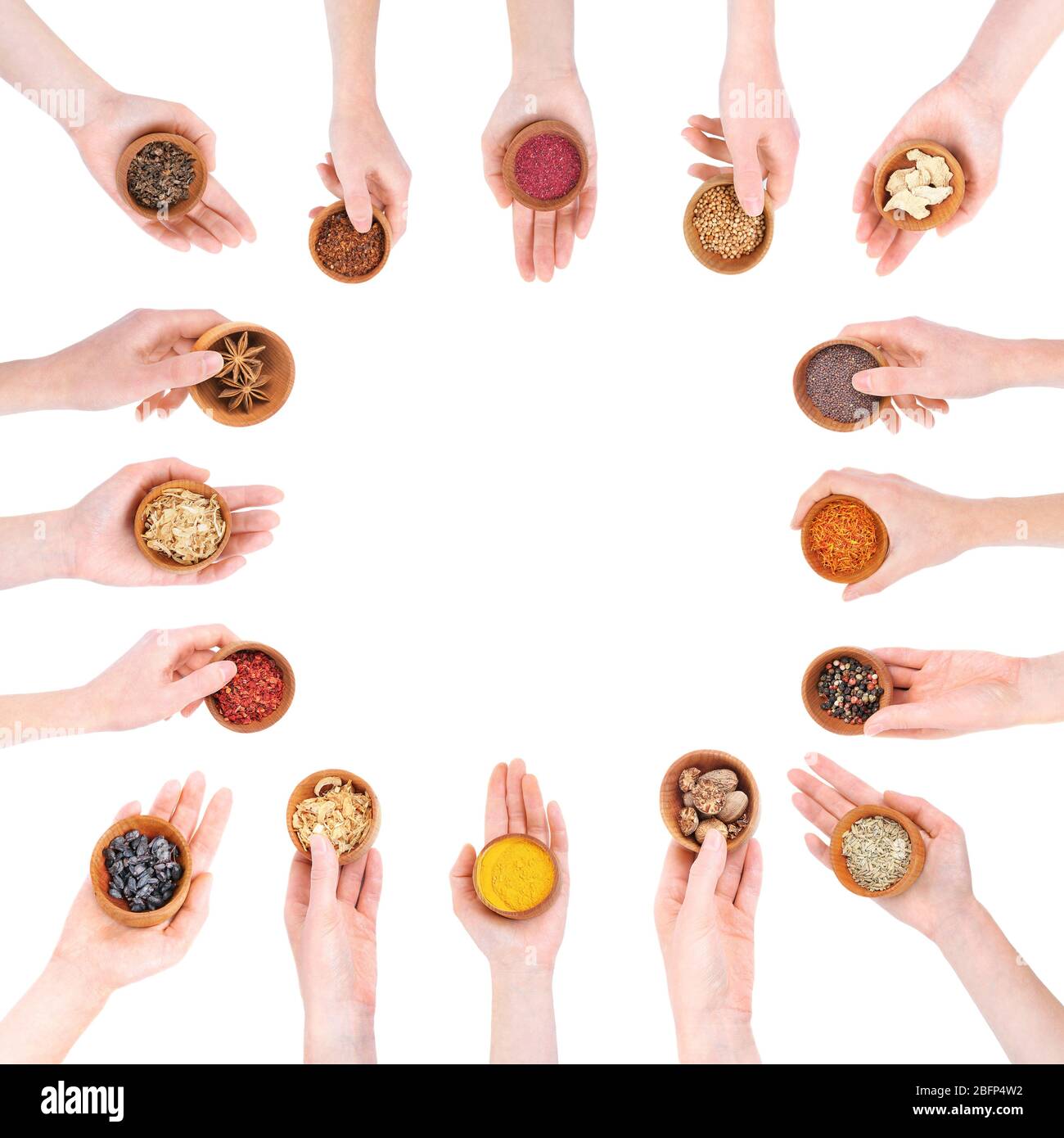Hands holding collection of different spices in wooden bowls, isolated ...