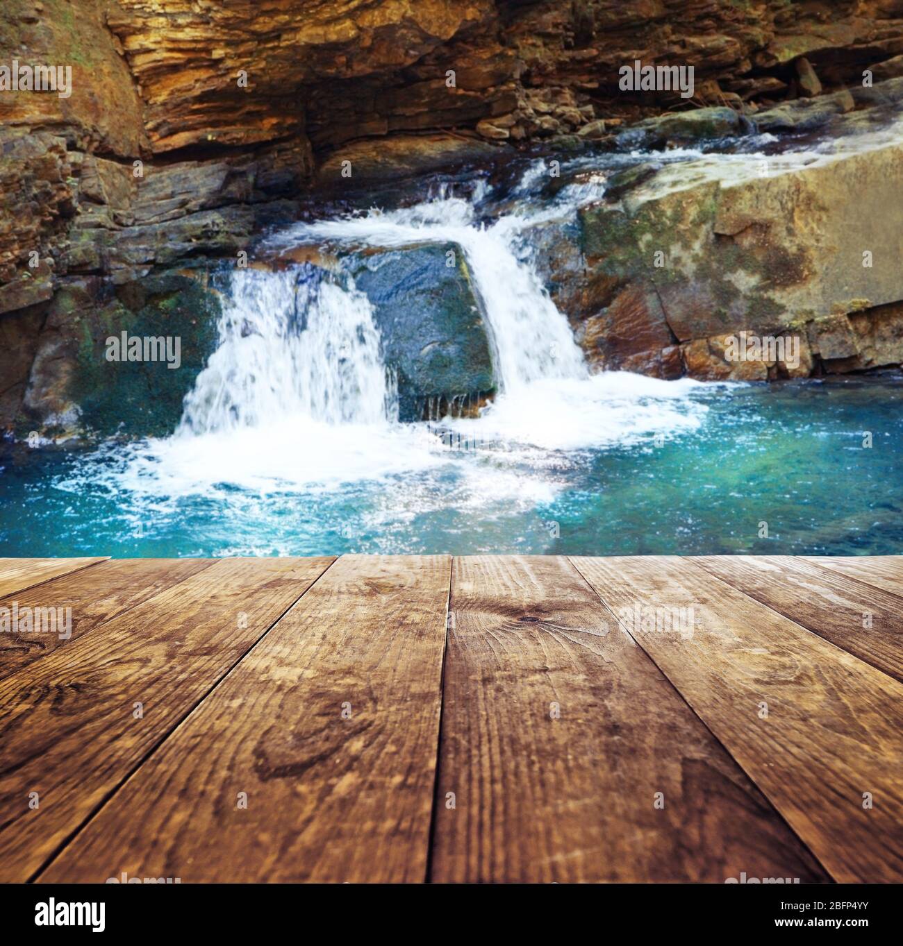 Empty wooden table on waterfall background. Space for your montage ...