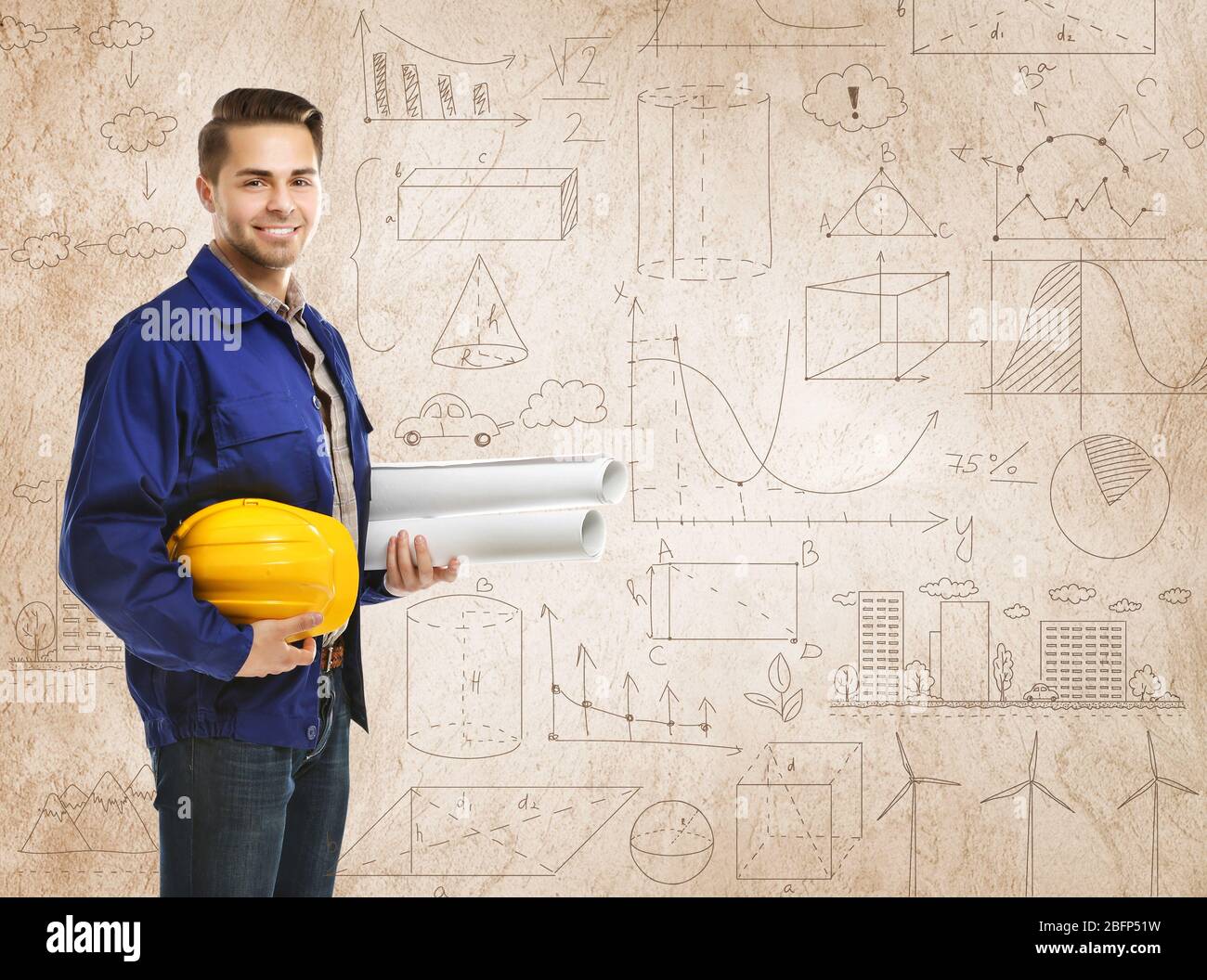 Engineer with blueprints and helmet on wall background Stock Photo - Alamy