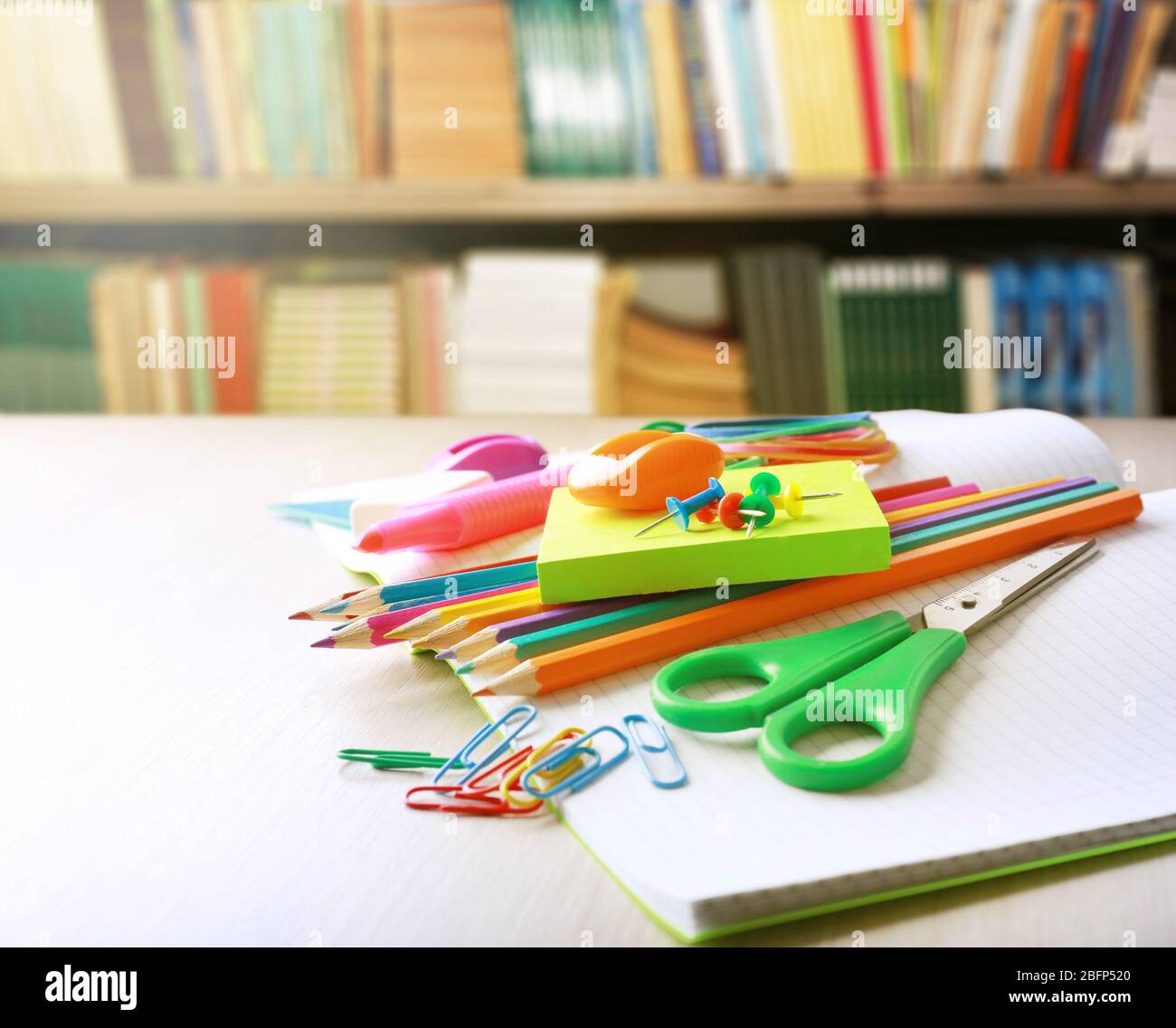 School supplies on blurred library background Stock Photo - Alamy