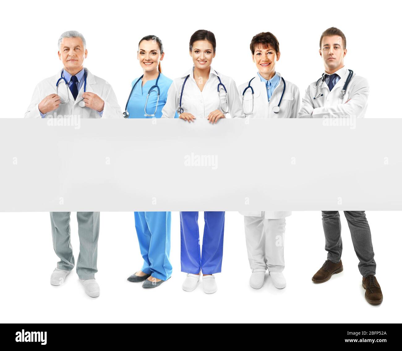 Smiling doctors with white banner, isolated on white Stock Photo - Alamy