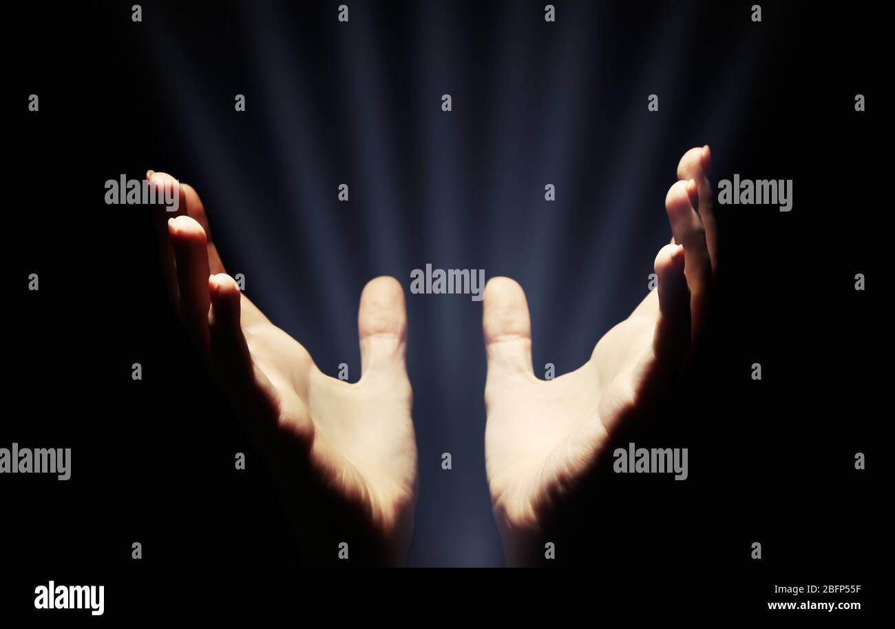 Female hands with light on dark background Stock Photo - Alamy