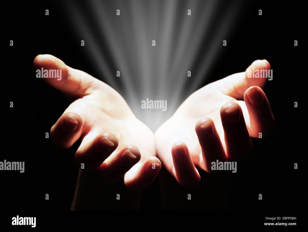 Female hands with light on dark background Stock Photo - Alamy