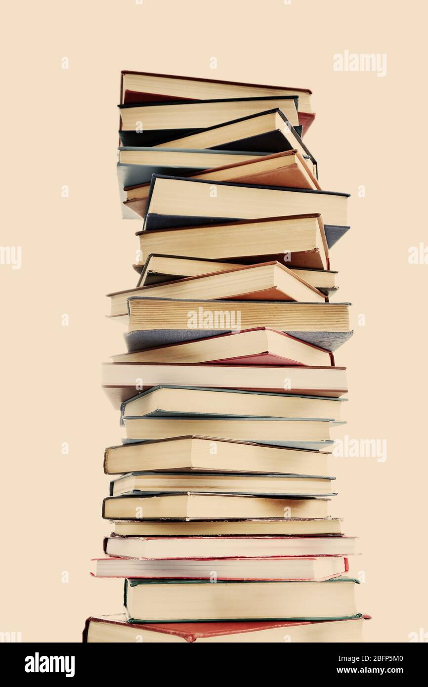High stack of books on light background Stock Photo - Alamy