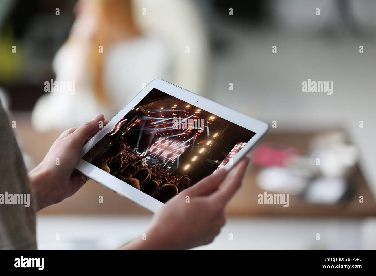Woman's hand tablet on blurred background using. Spotlight with laser ...