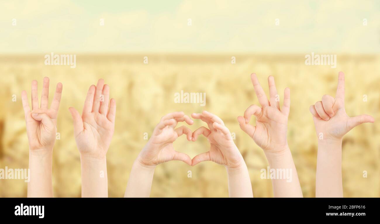 Children hands showing gestures on color background Stock Photo - Alamy
