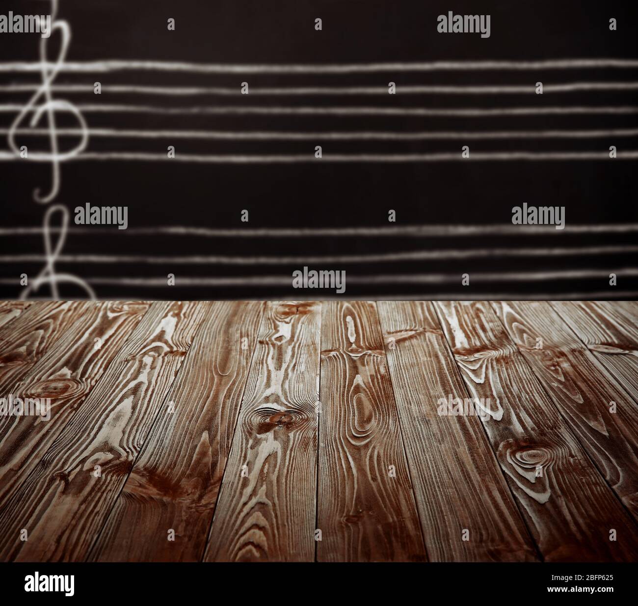 Wooden table on blackboard background. School concept Stock Photo - Alamy