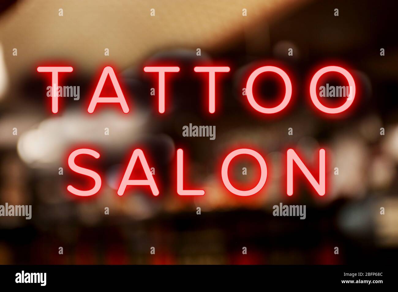 Text Tattoo Salon on blurred background Stock Photo - Alamy
