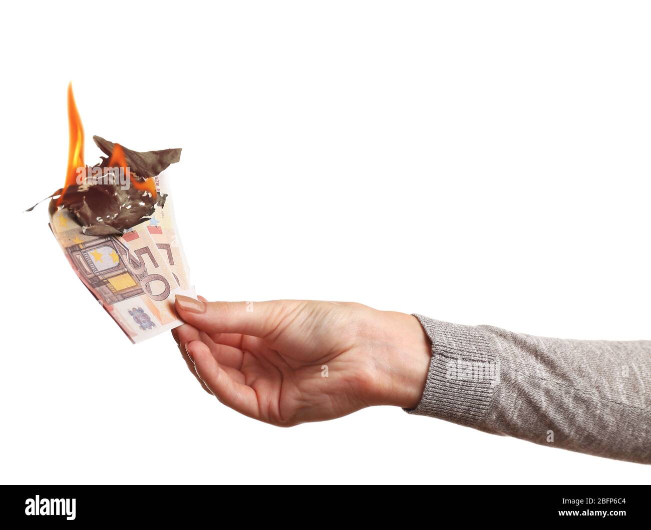 Female hand holding burning euro banknotes on white background Stock ...