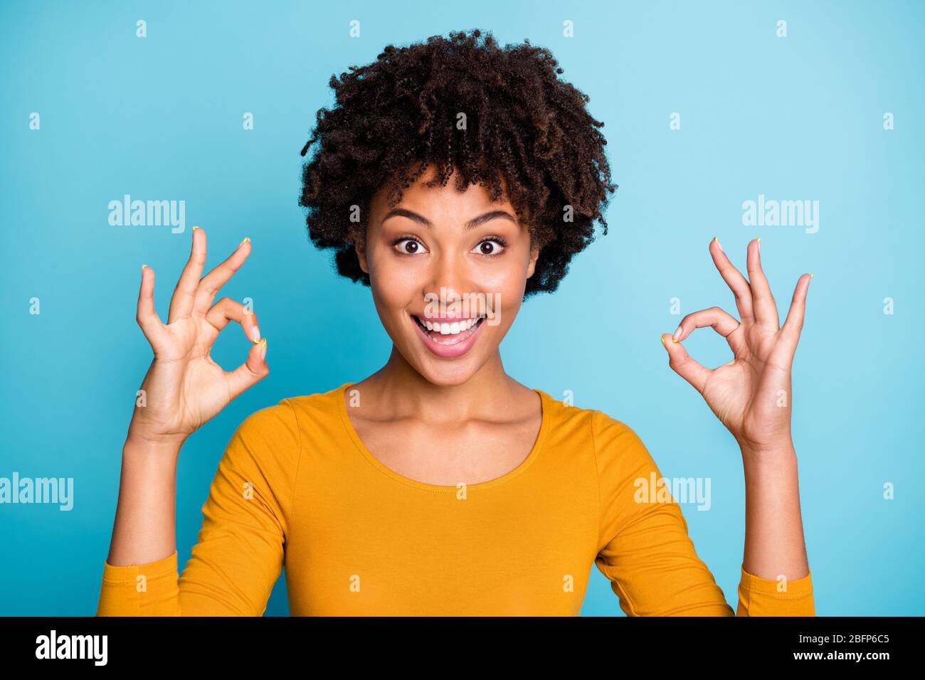 Portrait of crazy cheerful afro american girl show okay symbol look ...