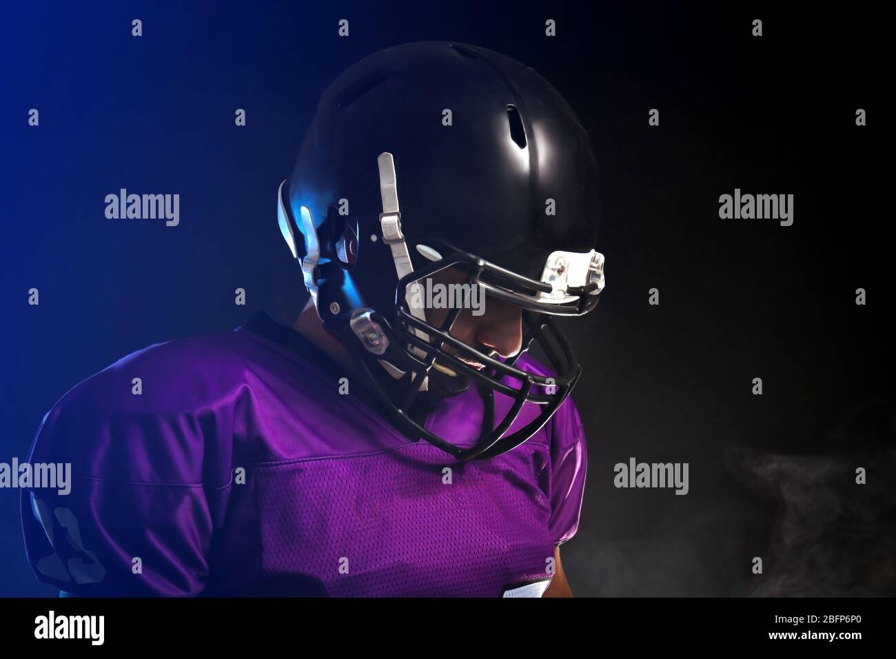 American football player on smoky background Stock Photo - Alamy