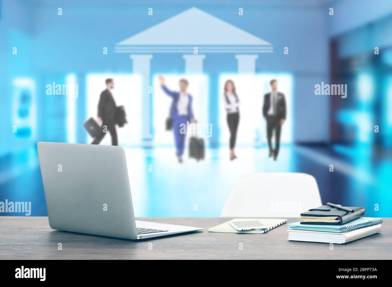 Law concept. Lawyer workplace with laptop. Blurred people silhouettes ...