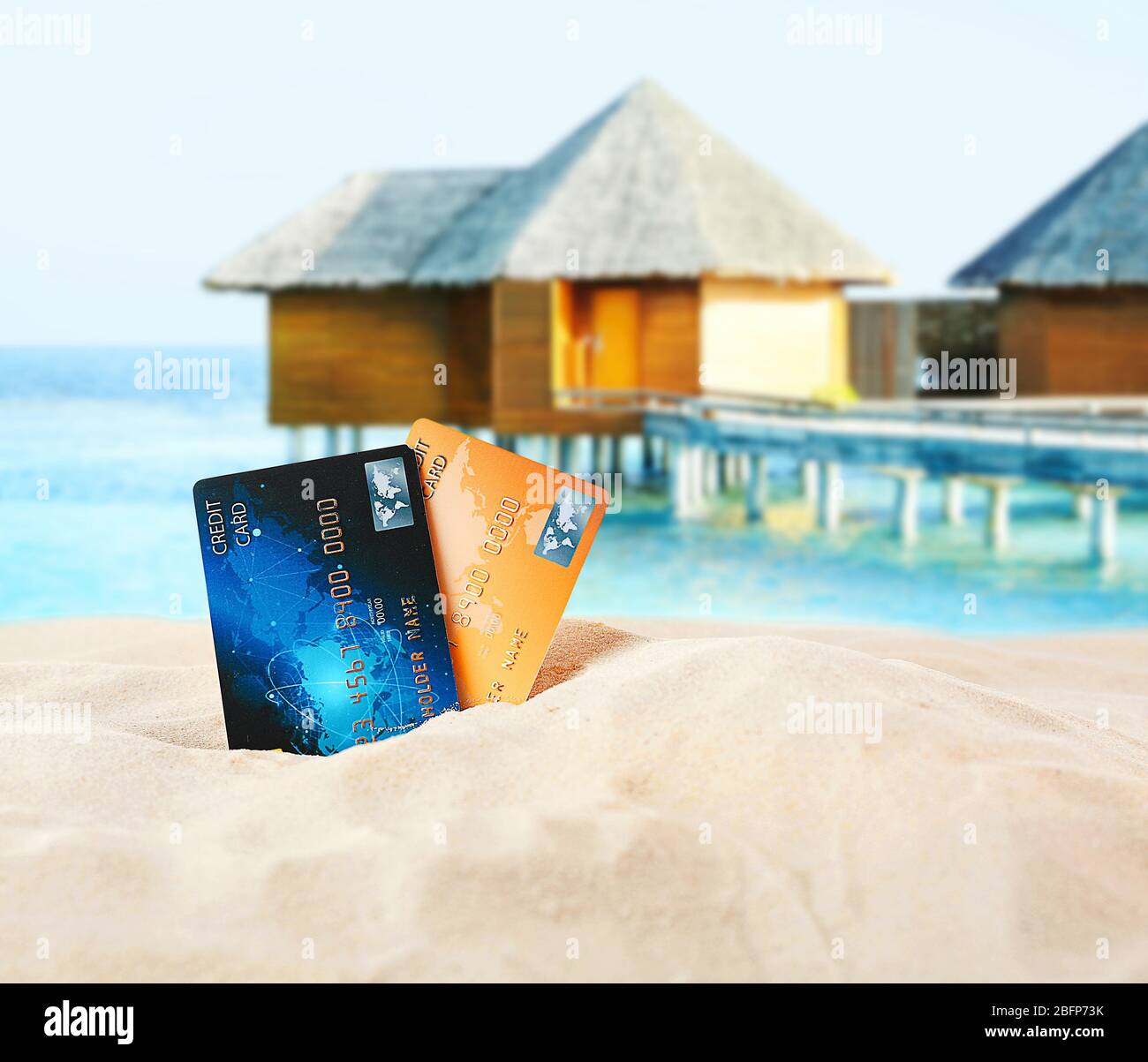 Credit cards on beach. Blurred water villa resort background Stock ...