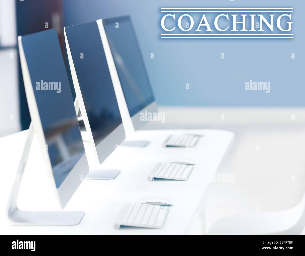 Modern computers in the office. Coaching concept Stock Photo - Alamy