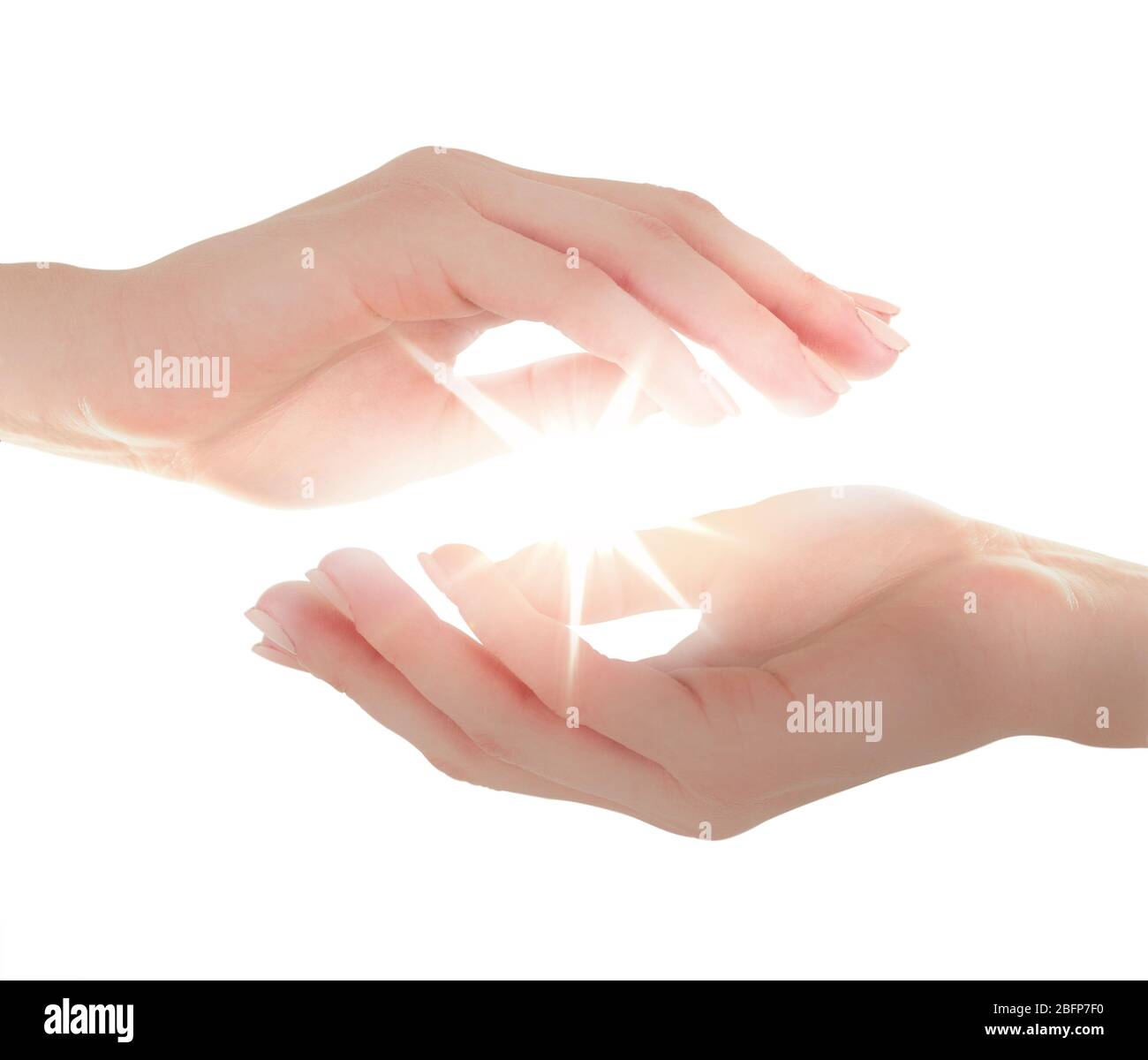 Female hands holding light on white background Stock Photo - Alamy