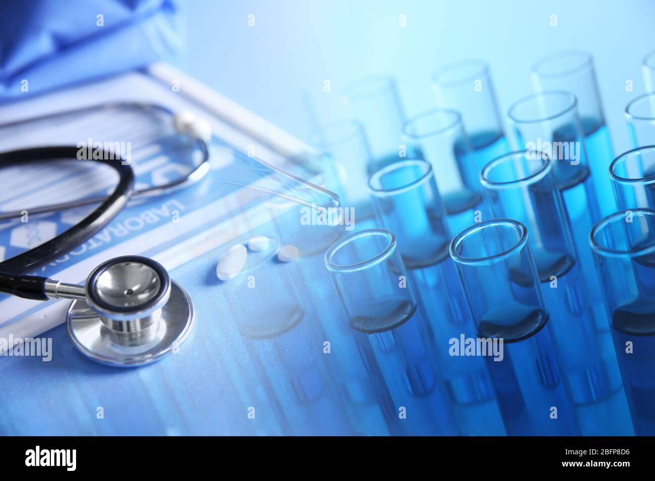 Test-tubes and medical equipment on a light blue background Stock Photo ...