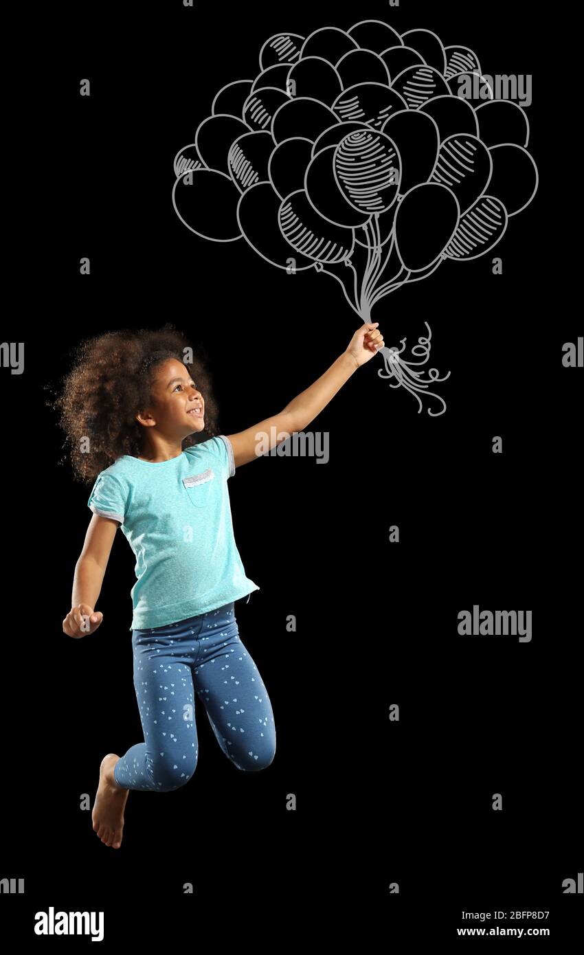 Happy African girl jumping on black background Stock Photo - Alamy