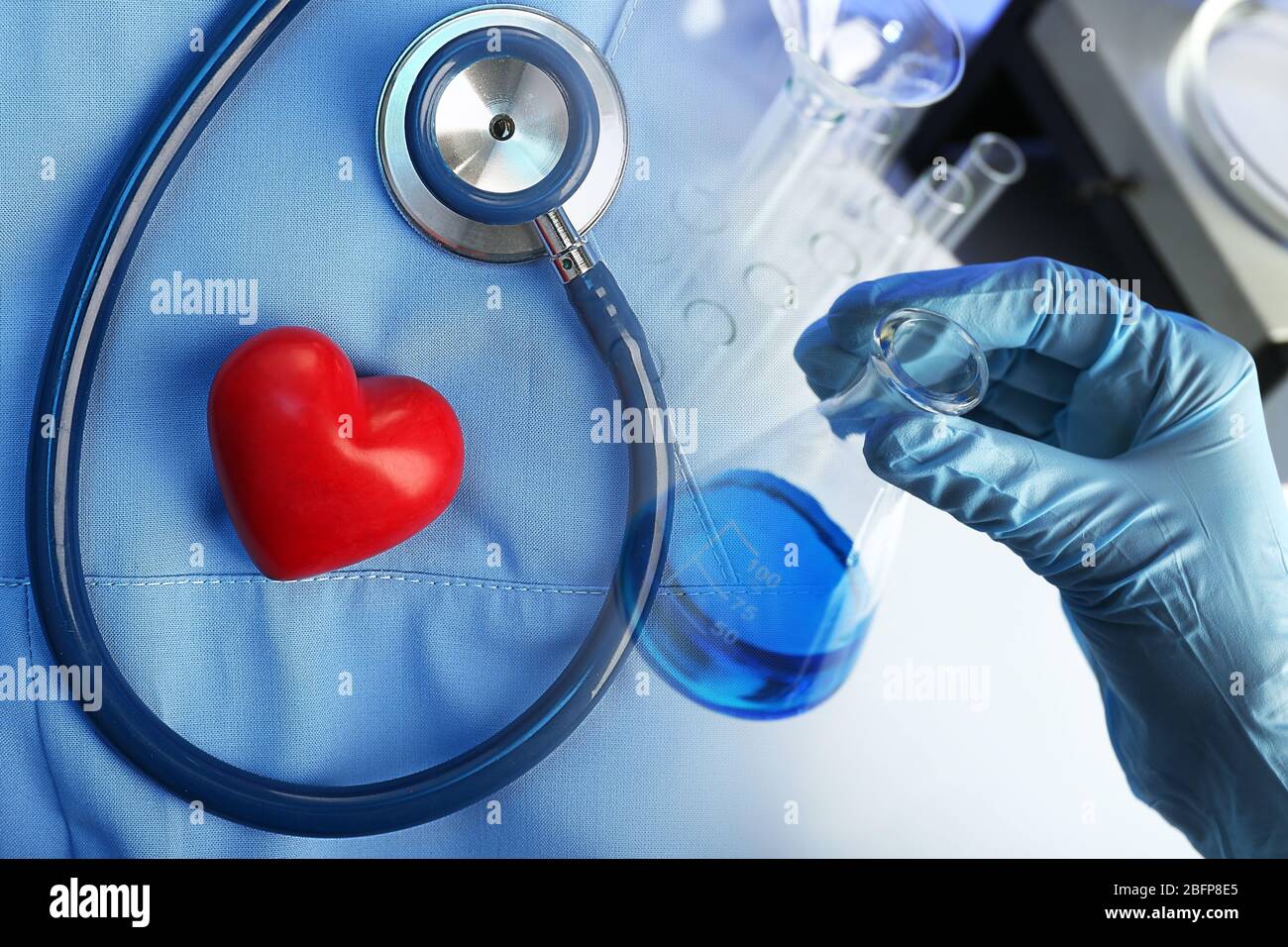Stethoscope with heart and test tube in scientist hand in laboratory ...