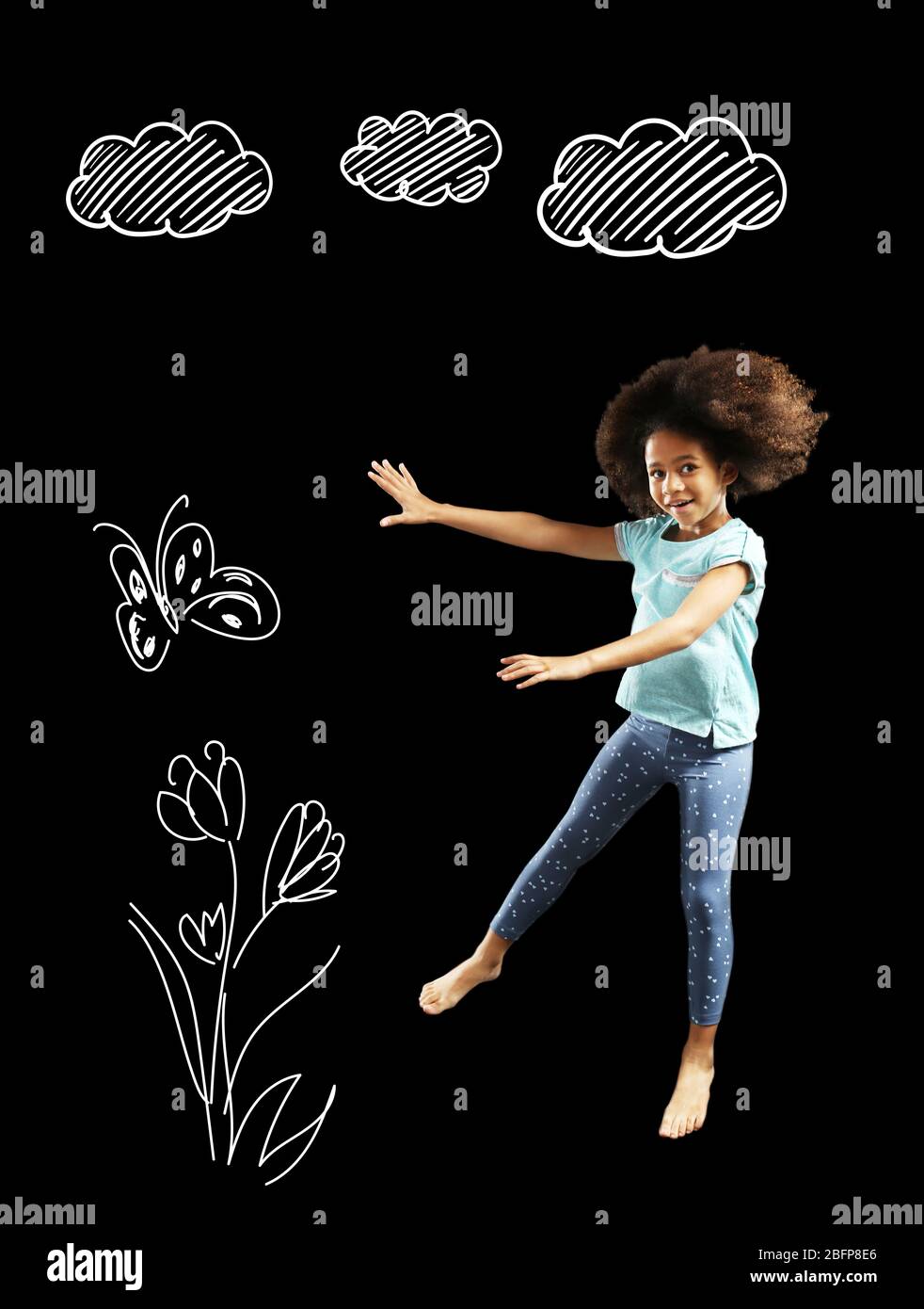 Happy African girl jumping on black background Stock Photo - Alamy
