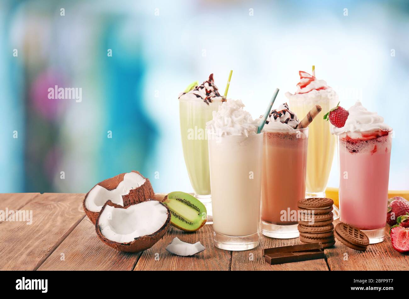 Delicious milkshakes on blurred background Stock Photo - Alamy